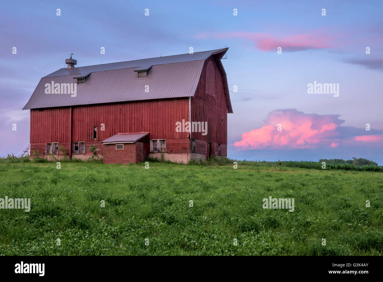 Red barn at sunset Stock Photo - Alamy