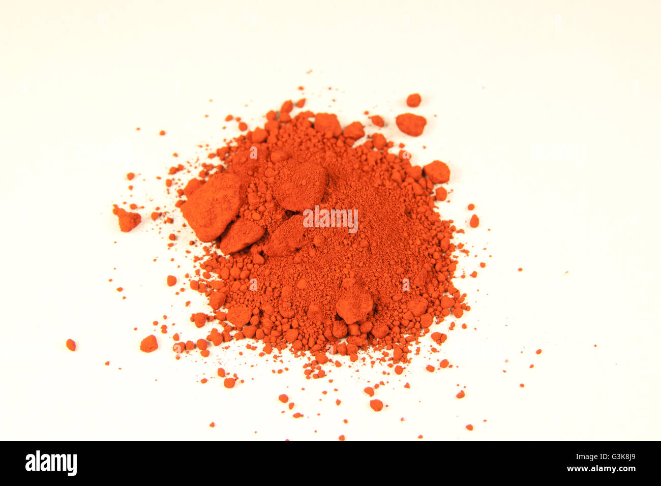 close up of a small portion of ferric red pigment isolated over white ...