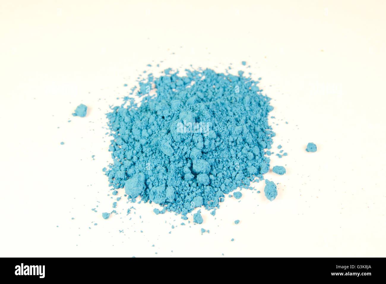 close up of a small portion of bright blue pigment isolated over white ...