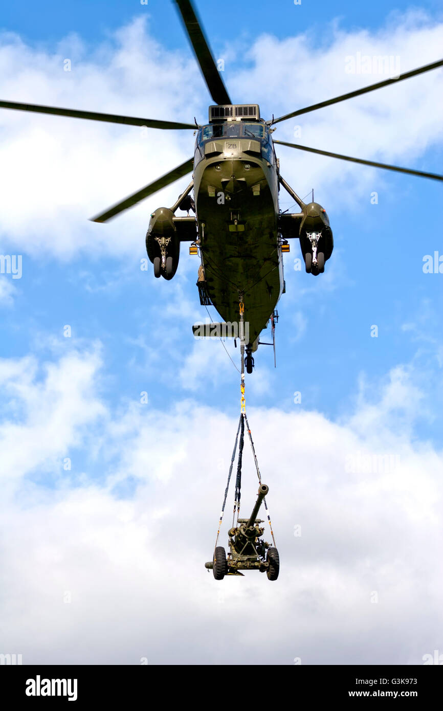 A Royal Navy Westland Sea King HC.4 helicopter with an underslung load ...