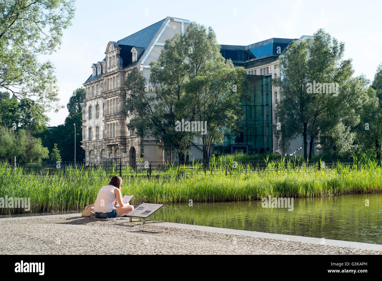 Girl reading a book seated Berlin Germany Stock Photo - Alamy
