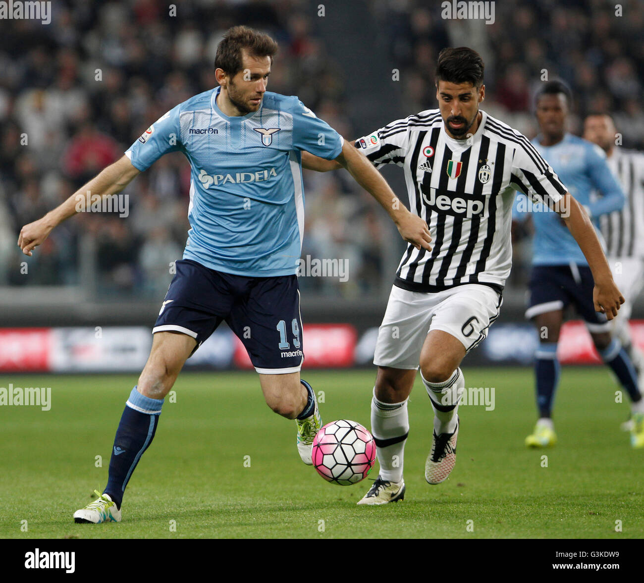 Turin, Italy. 20th Apr, 2016. Lazio's Senad Lulic, left, is challenged ...