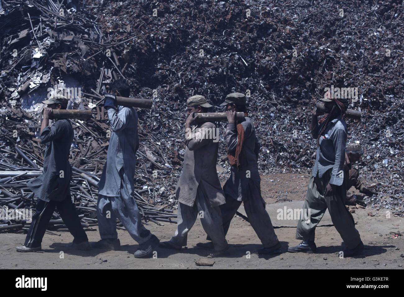 Pakistani blacksmiths work at an iron molding factory in an industrial ...