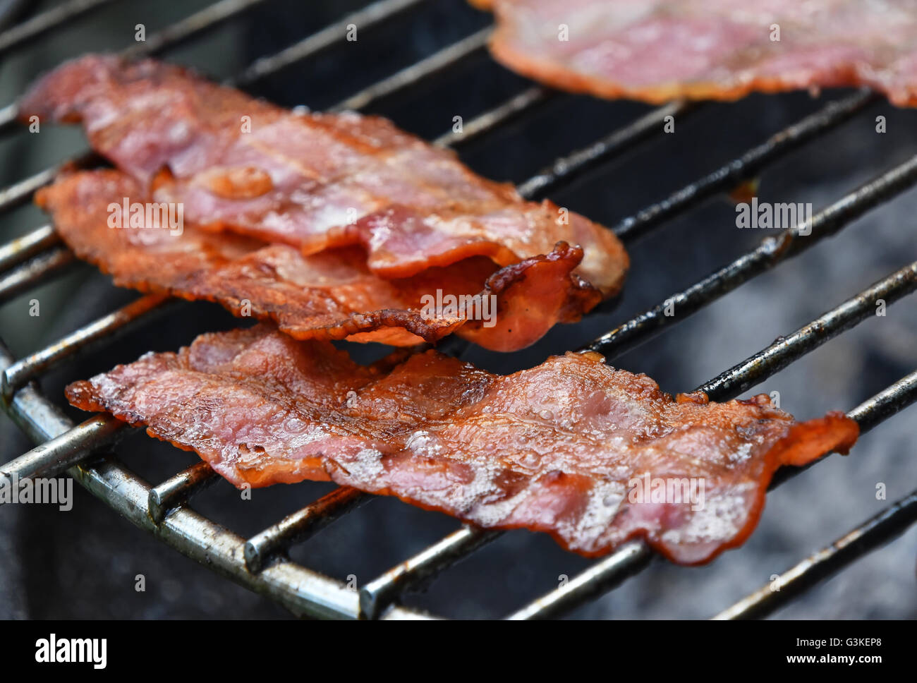Seceral crispy smoked grilled barbecue bacon slices, cooked on bbq ...