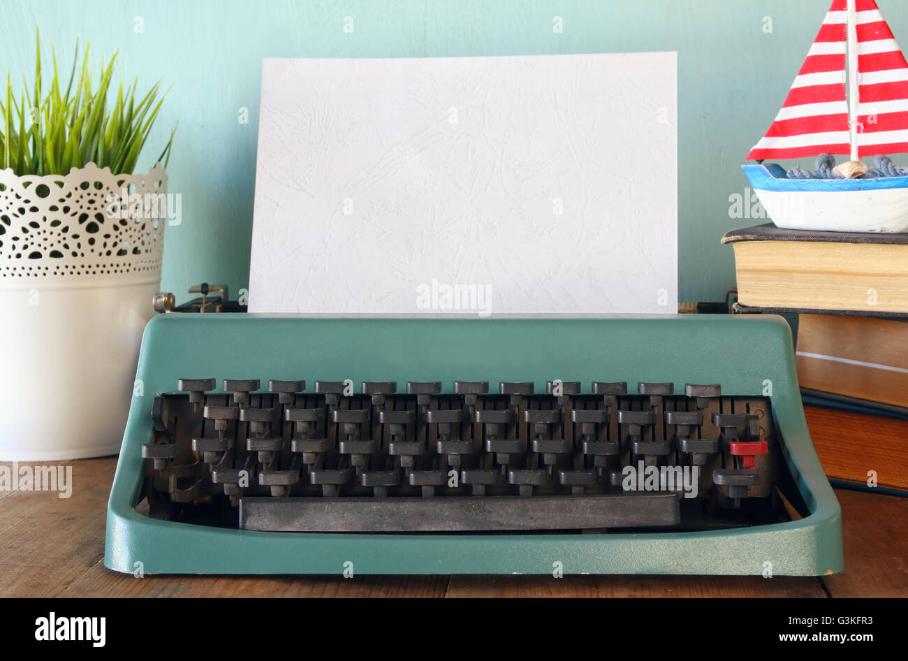 photo of vintage typewriter with blank page on wooden table Stock Photo ...