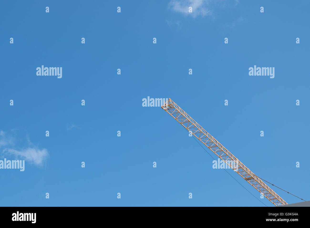yellow crane construction site blue sky. yellow high long crane arrow ...