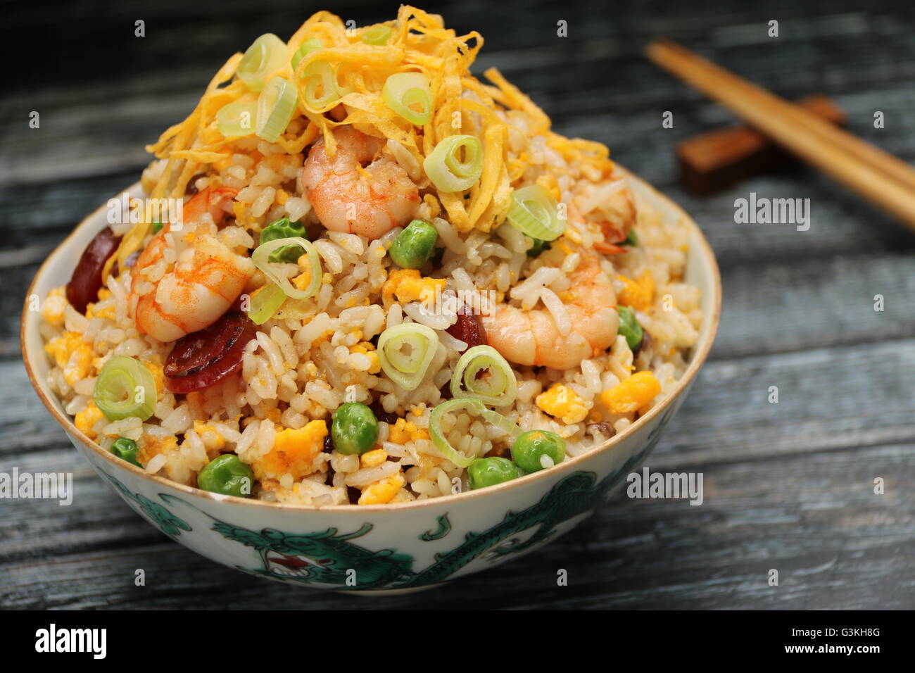 Chinese fried rice cooked with Chinese sausage, shrimps, egg, peas and ...