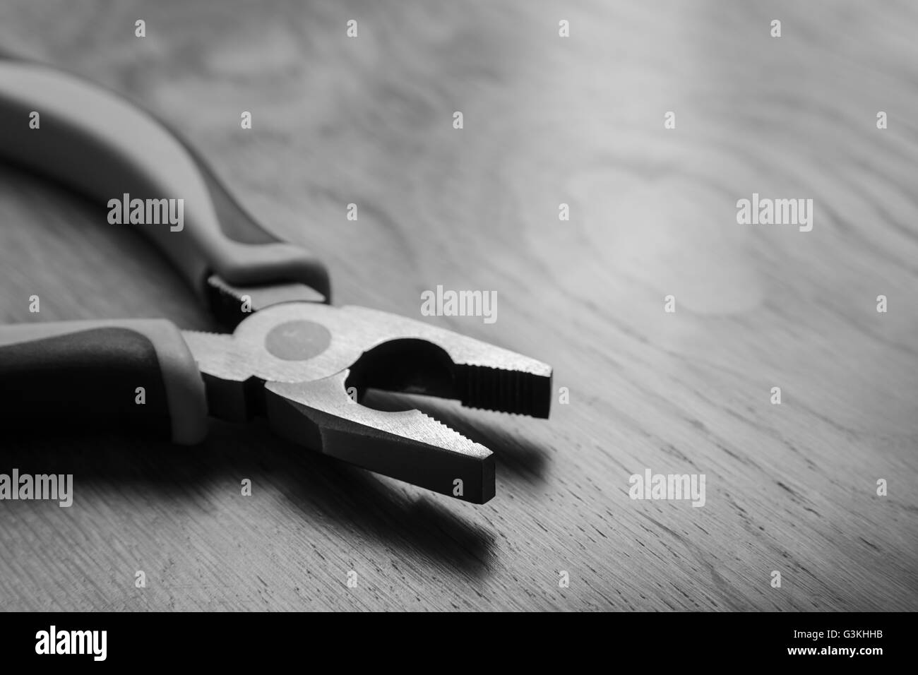 Metal pliers on table Stock Photo - Alamy