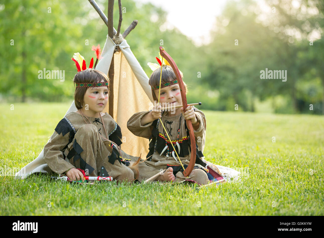 Cute portrait of native american boys with costumes, playing outdoor in ...
