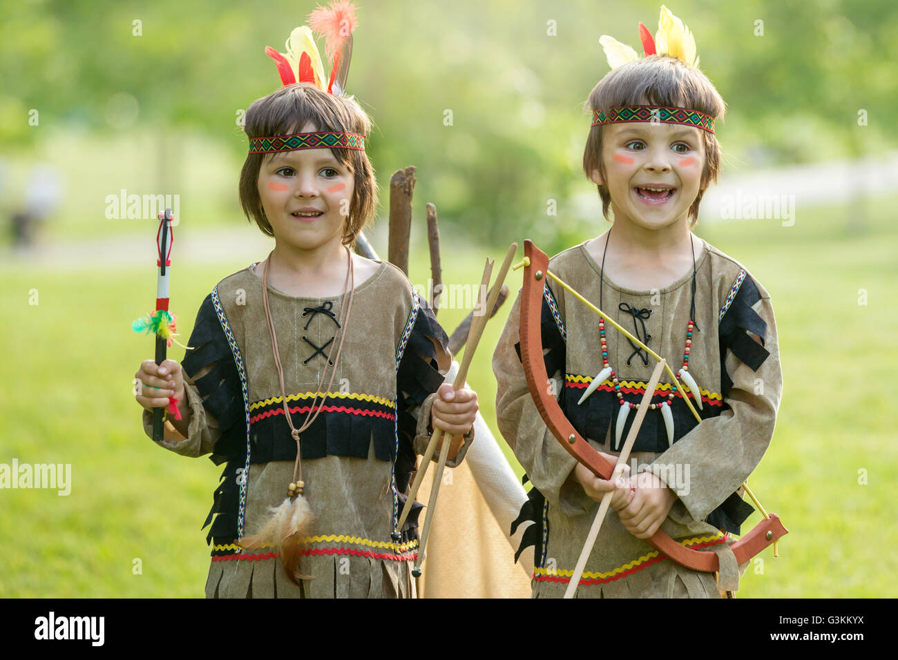 Cute portrait of native american boys with costumes, playing outdoor in ...