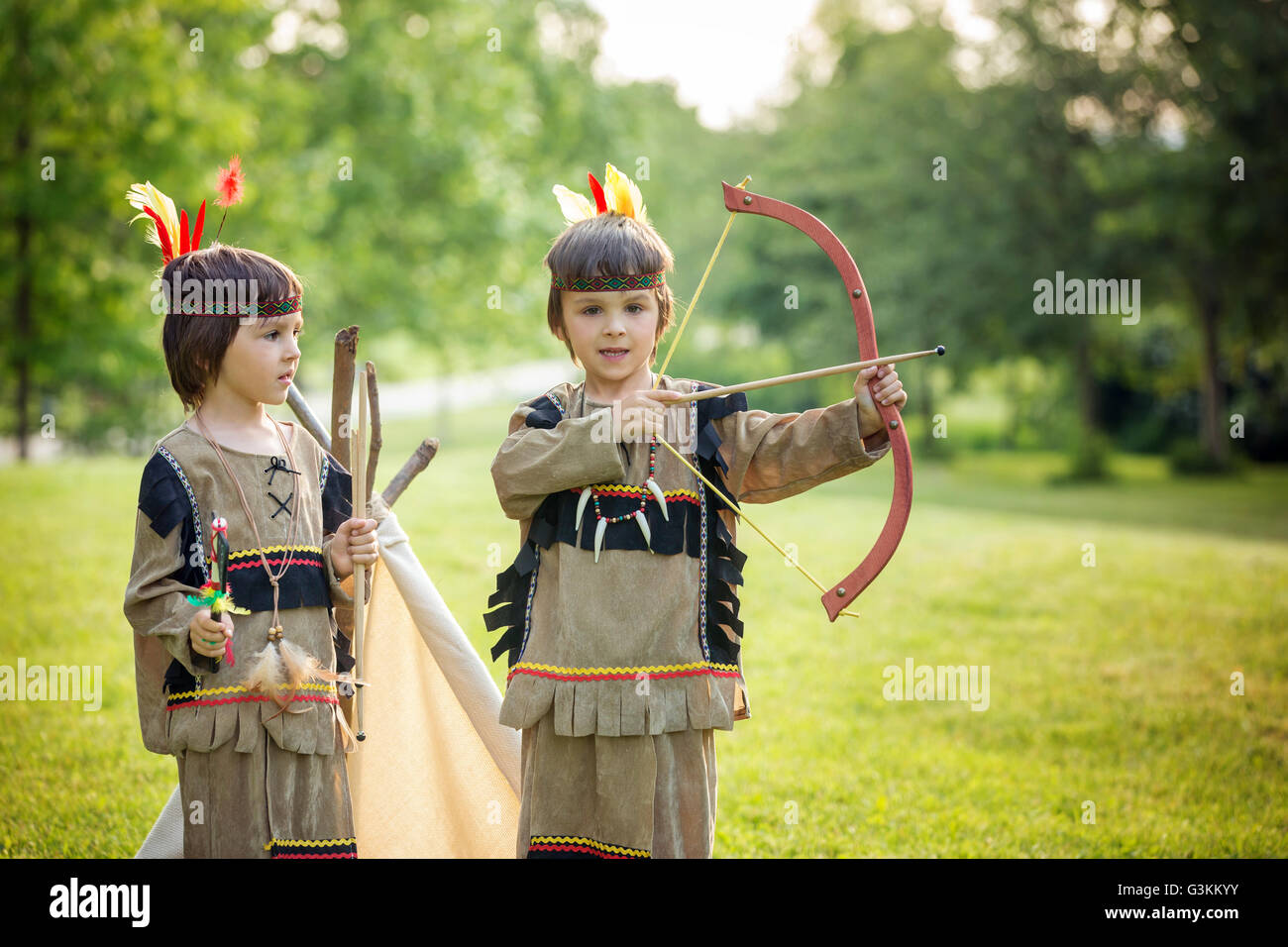 Cute portrait of native american boys with costumes, playing outdoor in ...