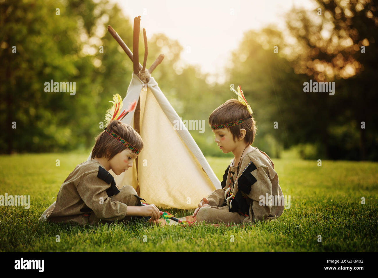 Cute portrait of native american boys with costumes, playing outdoor in ...