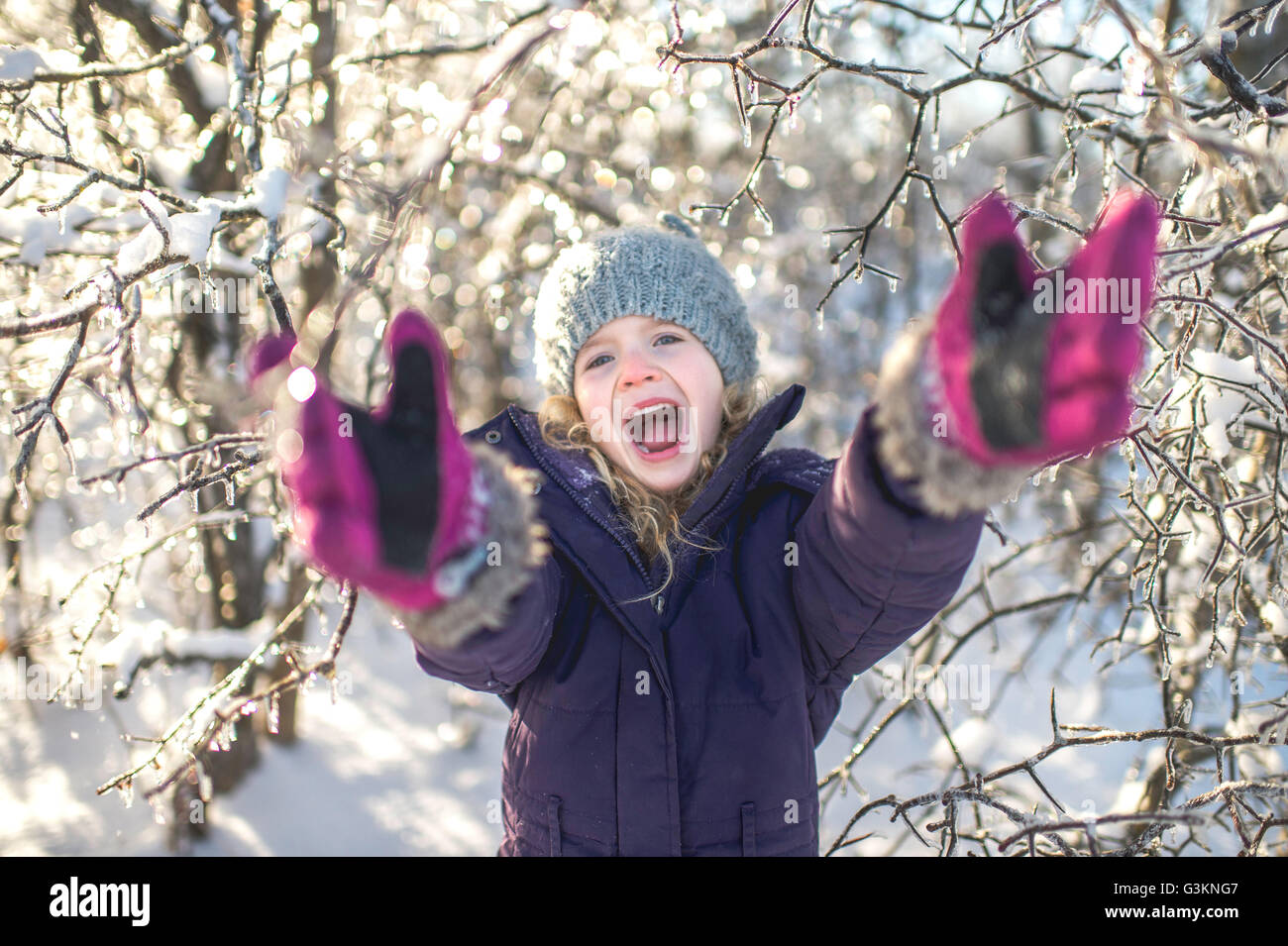 Young girl laughing, arms outstretched, in snowy landscape Stock Photo ...