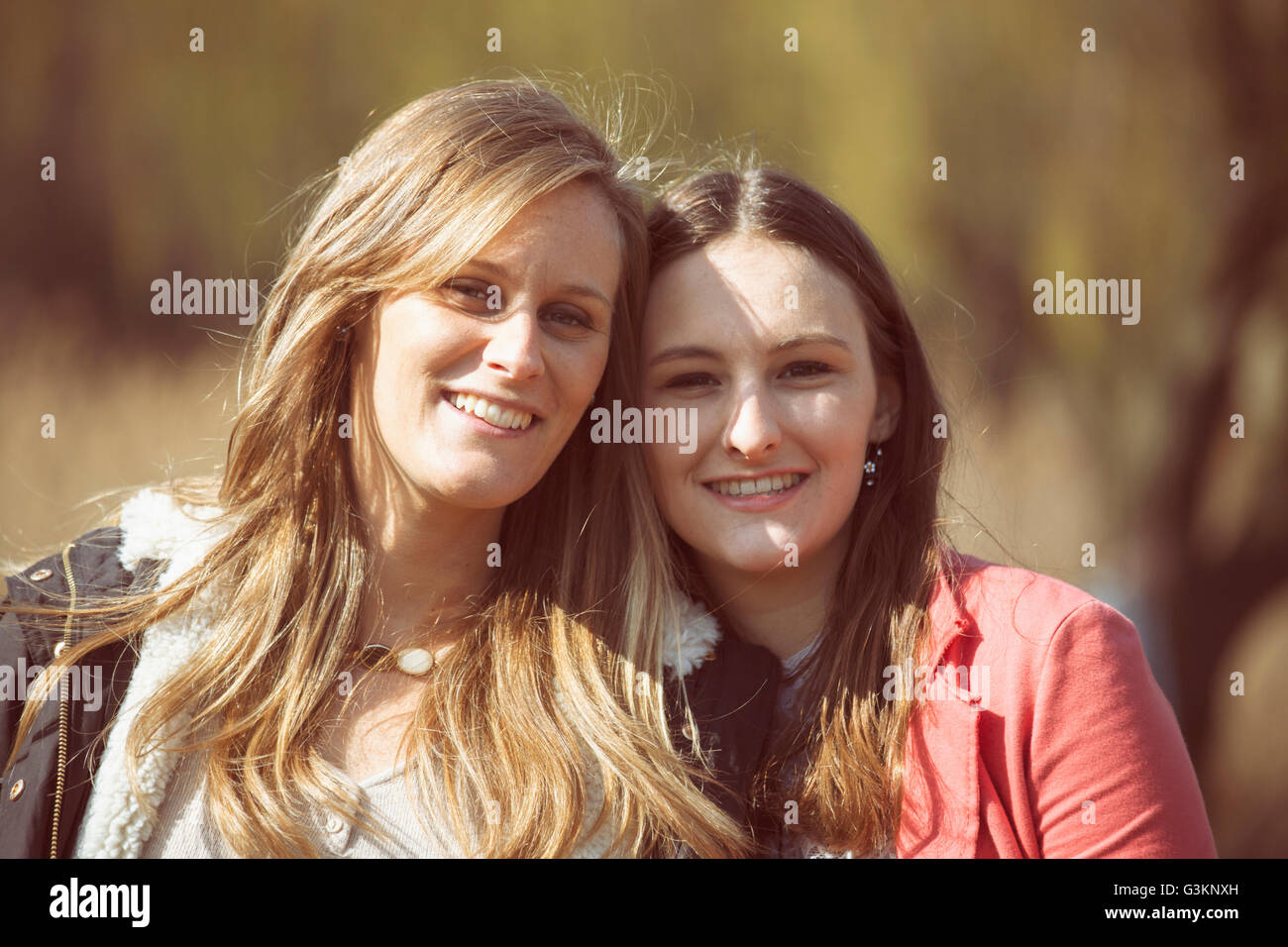 Portrait of female friends looking at camera smiling Stock Photo - Alamy