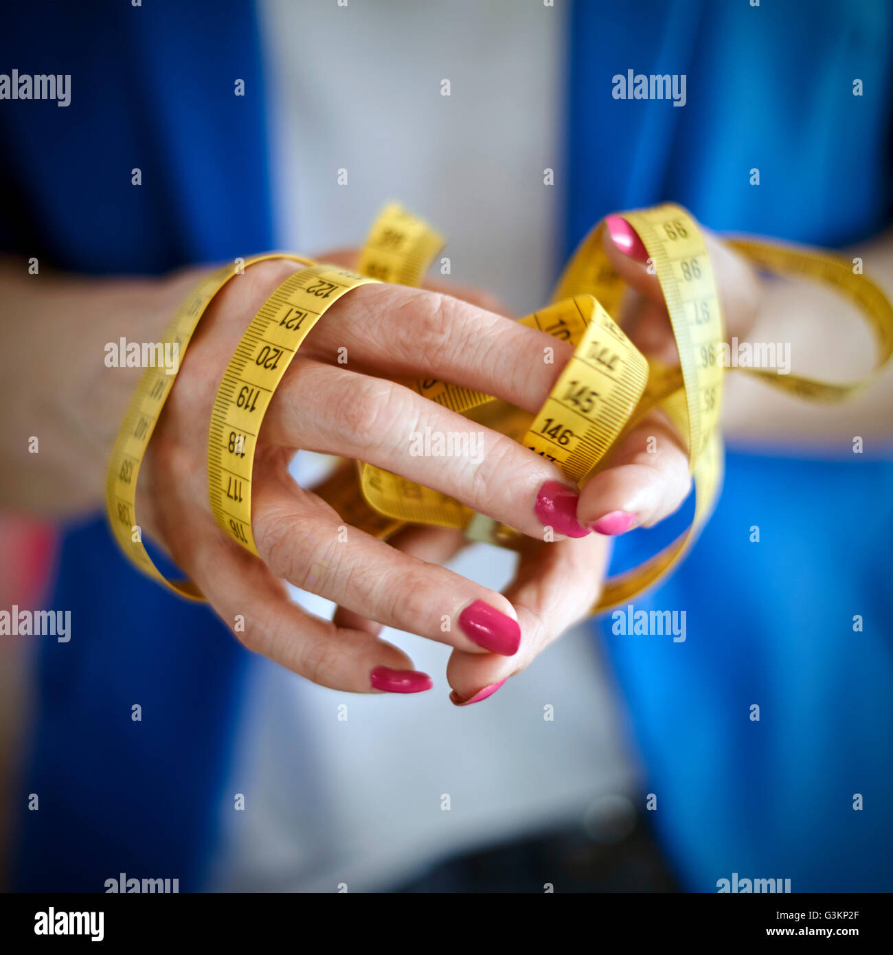 Cropped view of woman hands holding tape measure Stock Photo - Alamy