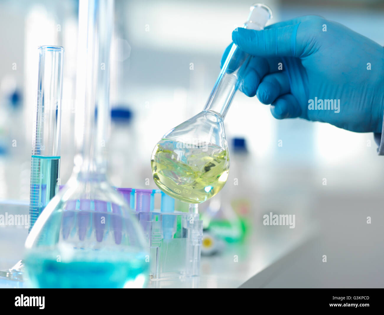 Scientist preparing a chemical formula in a conical flask during an ...