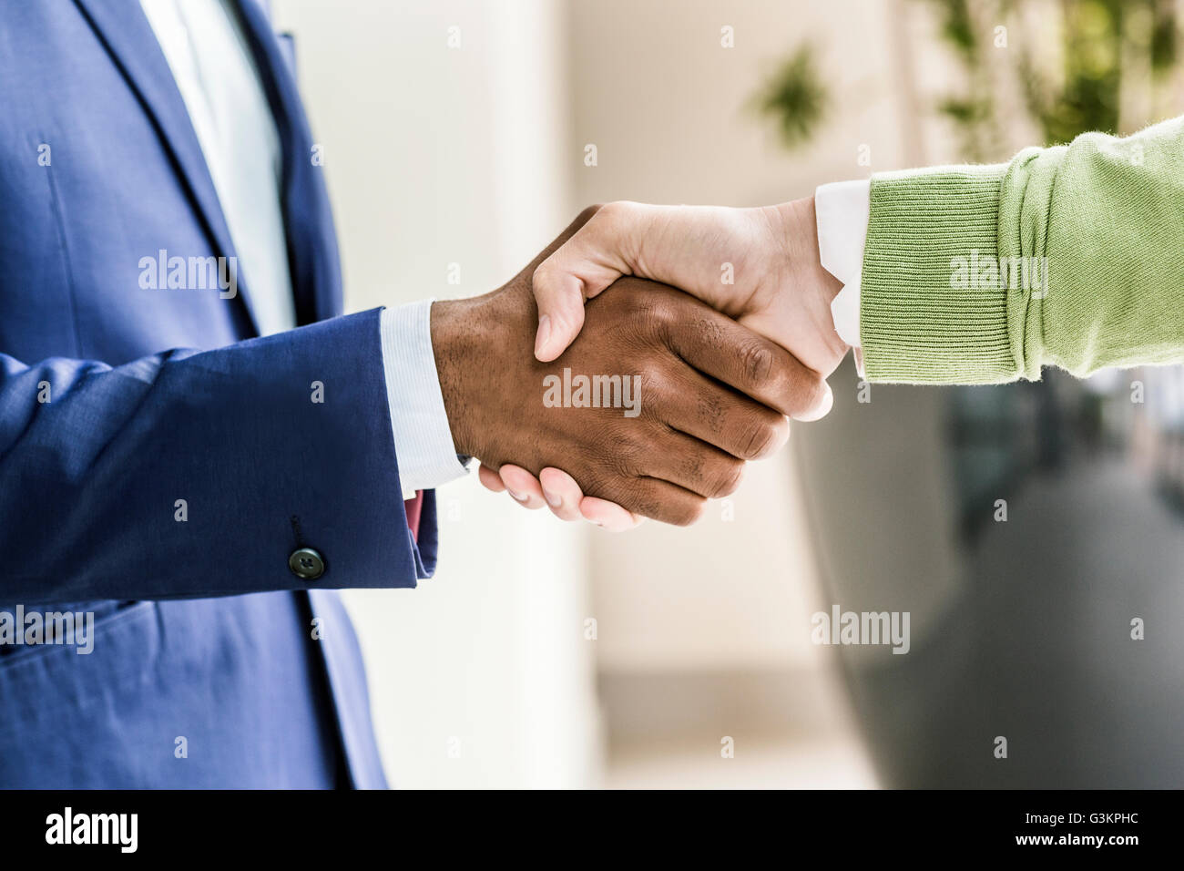 Close up of businessmen shaking hands outside office building Stock ...