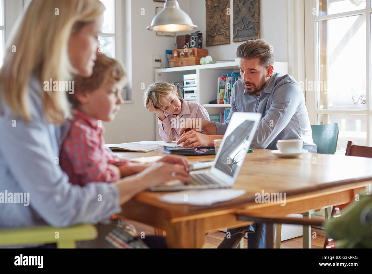 Parents and sons working in home office Stock Photo - Alamy