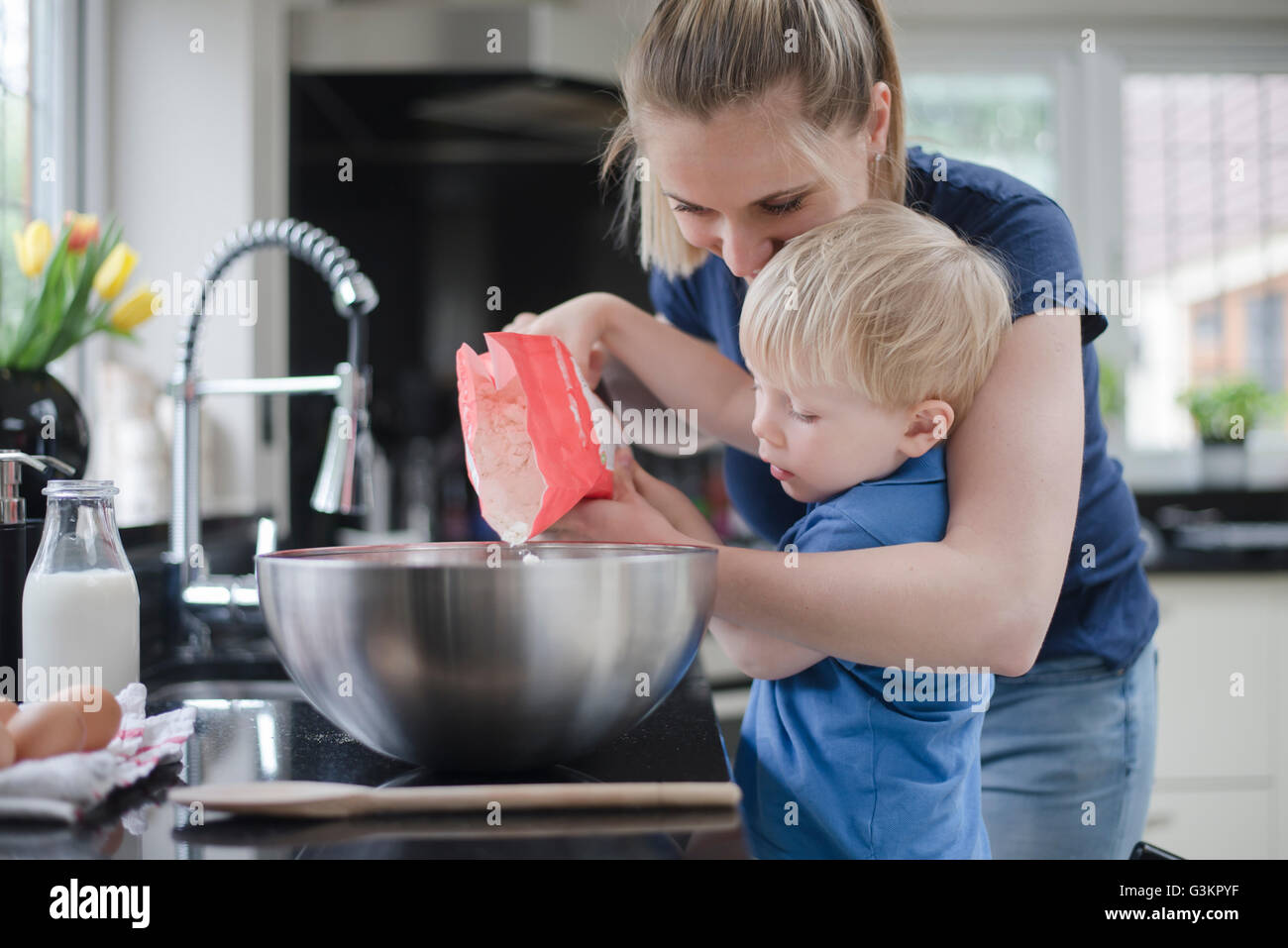 Mother helping son bake cake Stock Photo - Alamy