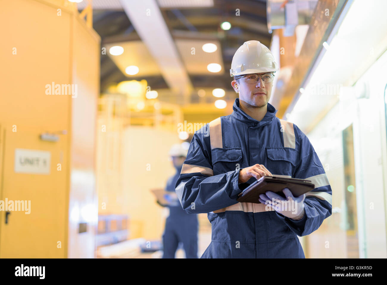 Portrait of worker in generating hall in hydroelectric power station ...