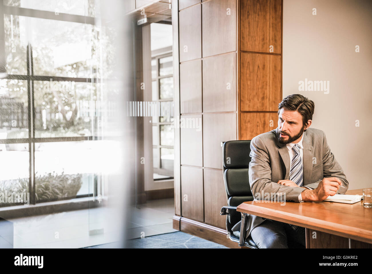 Businessman sitting at desk hi-res stock photography and images - Alamy