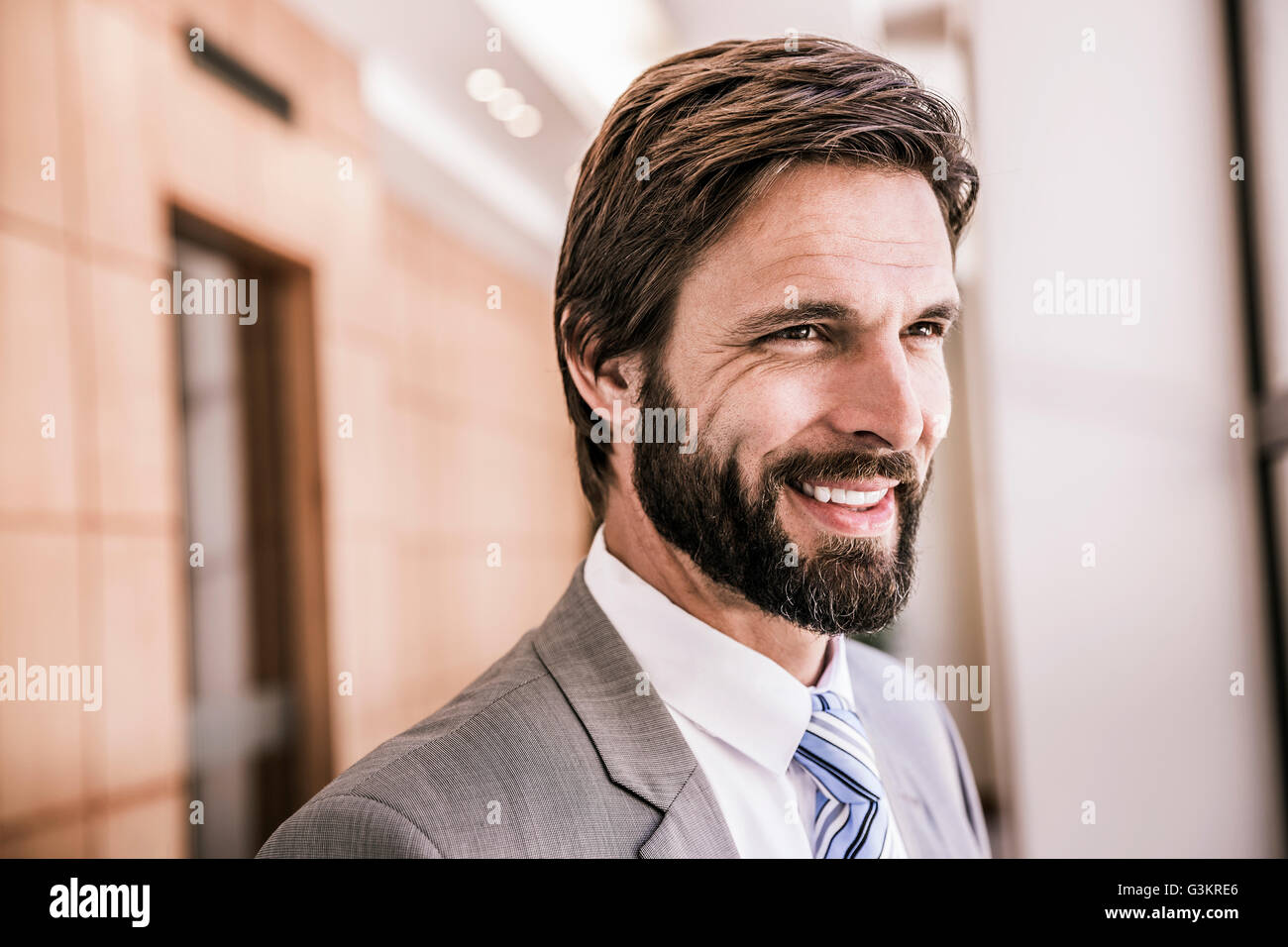 Bearded business man looking away smiling Stock Photo - Alamy Bearded business man looking away smiling Stock Photo - Alamy