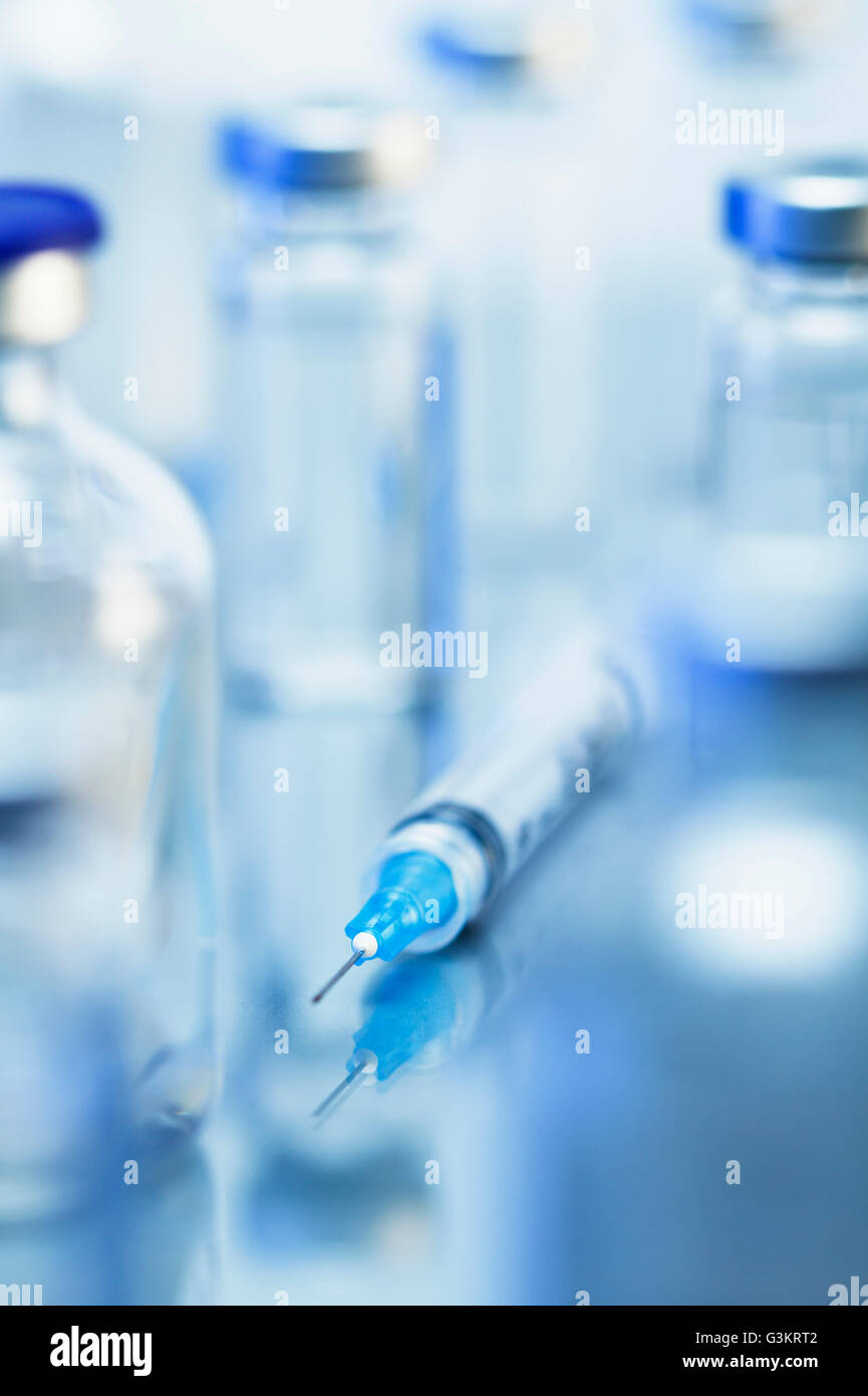 Syringe. Disposable plastic medical syringe surrounded by sealed ...