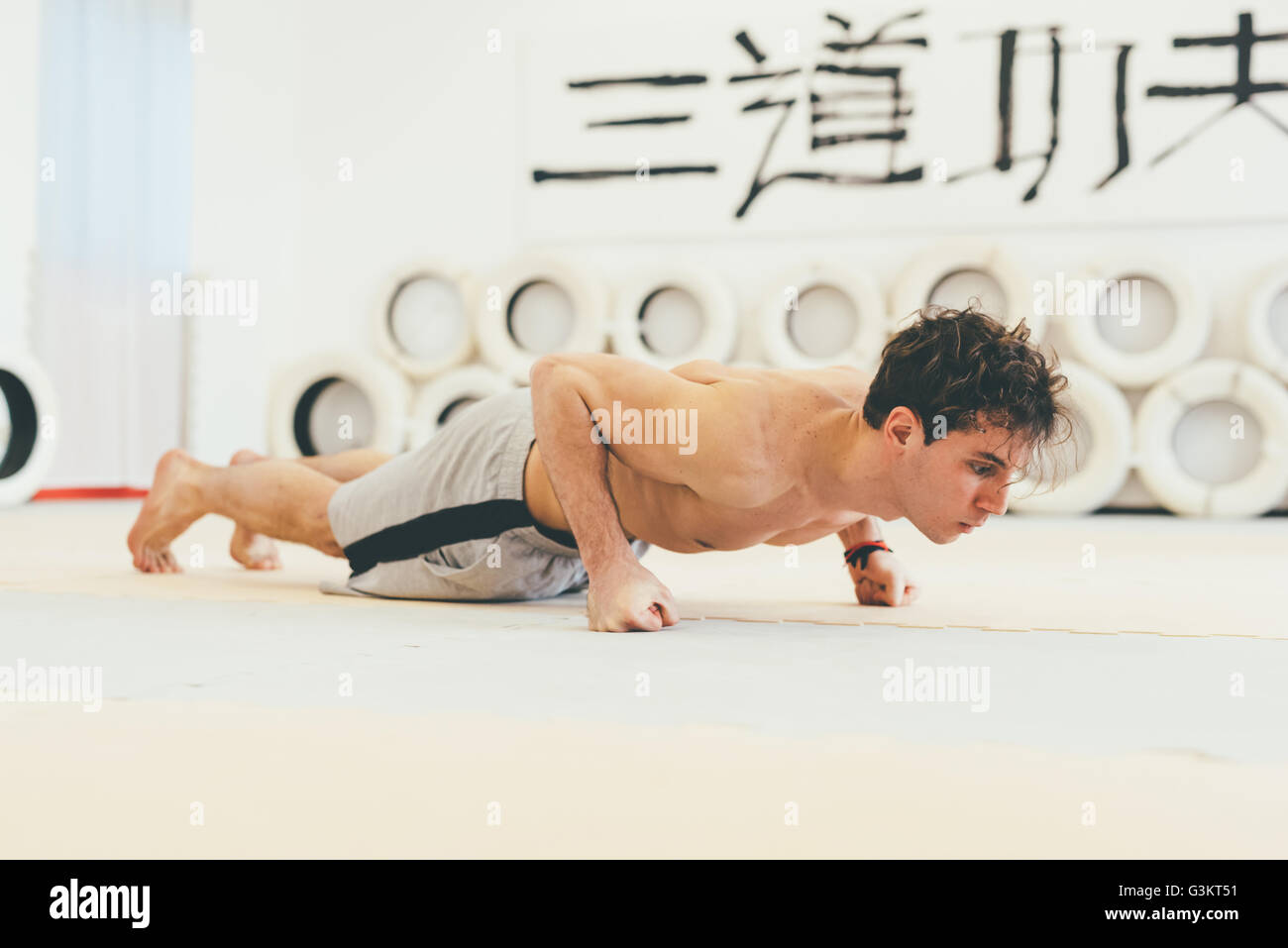 Man doing push up on fists Stock Photo - Alamy