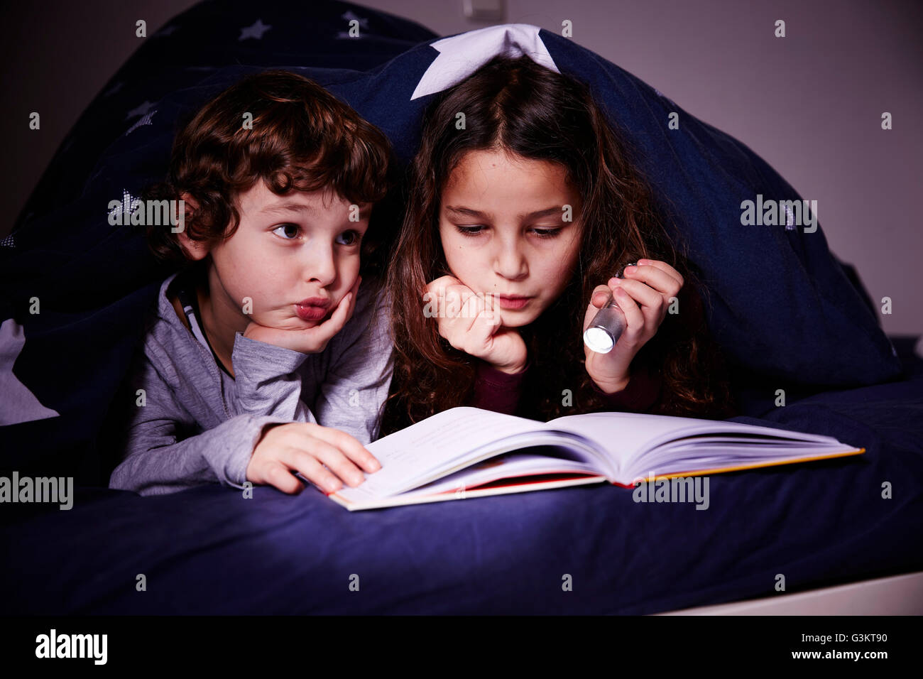 Sister reading book hi-res stock photography and images - Alamy
