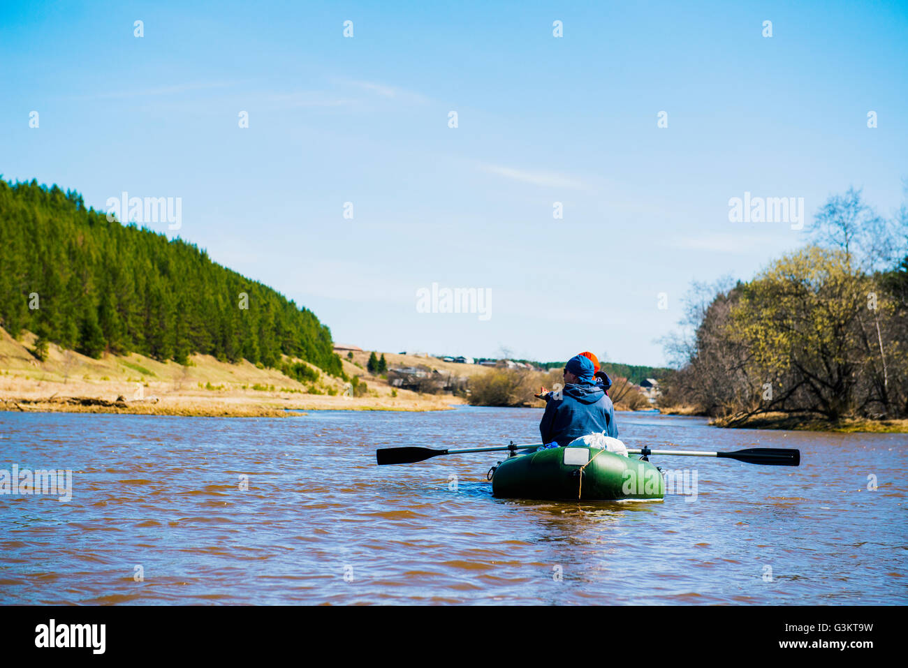 Rear view of couple rowing on river in dinghy Stock Photo - Alamy