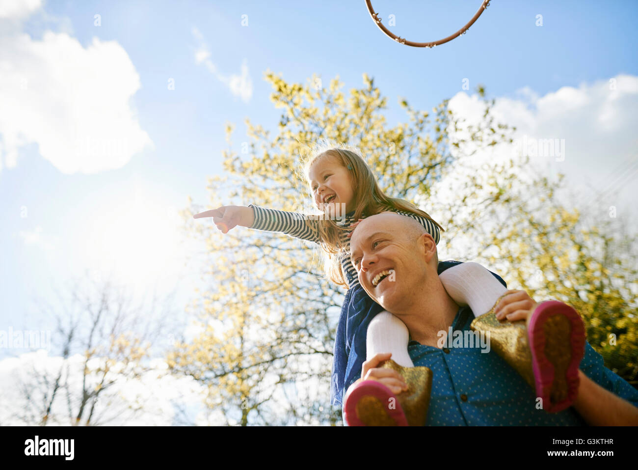 Father carrying daughter on shoulders Stock Photo - Alamy