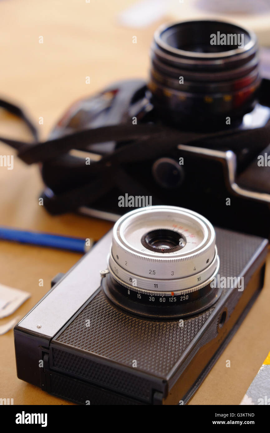 Two traditional camera's on table Stock Photo - Alamy
