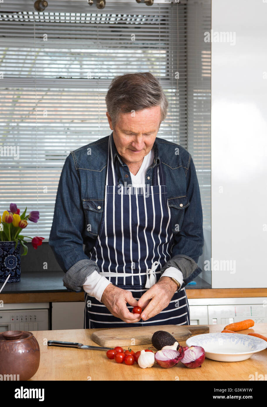 Man preparing food in kitchen Stock Photo - Alamy