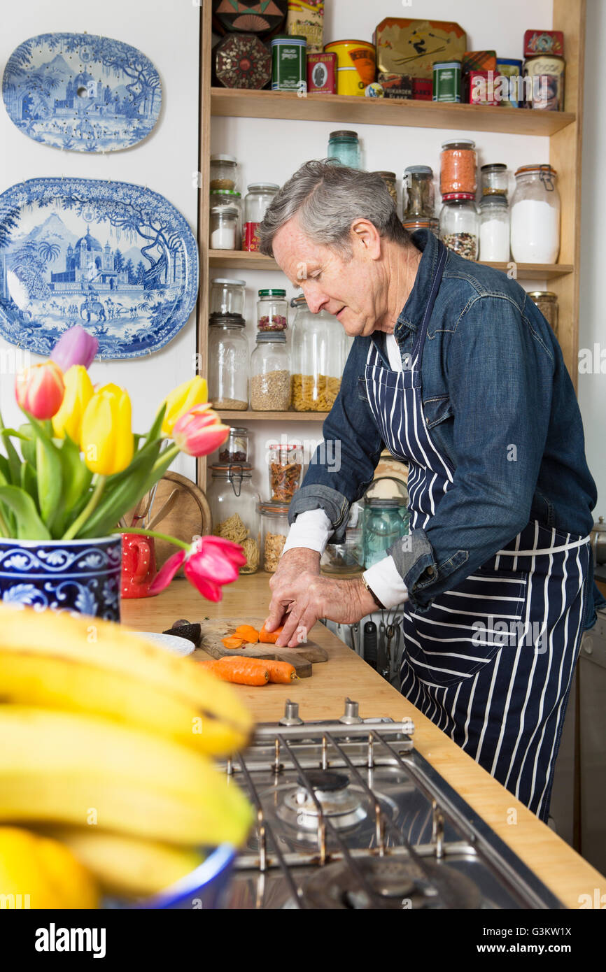Man preparing food in kitchen Stock Photo - Alamy