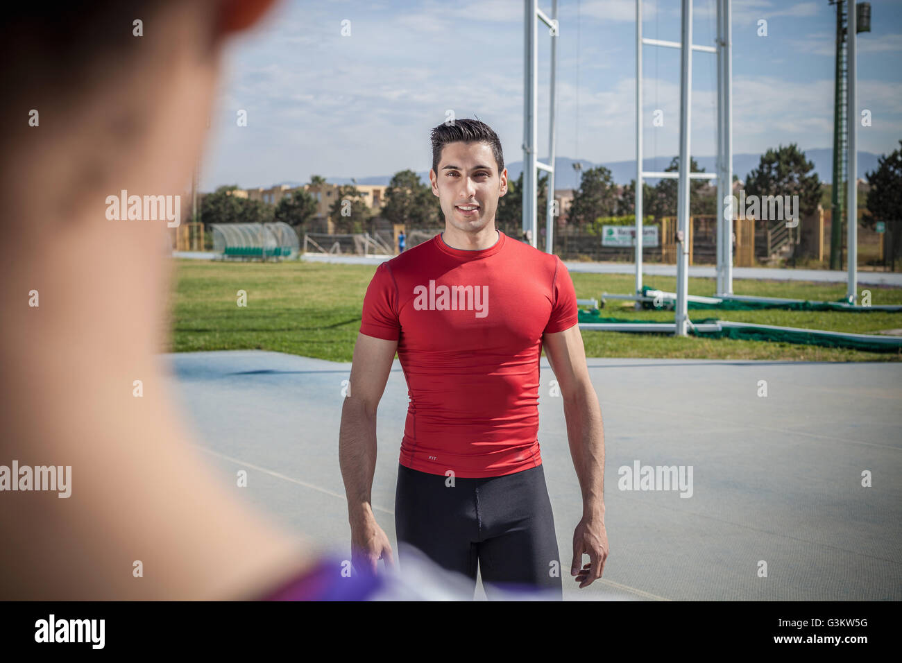 Over shoulder view of young man training at sport facility Stock Photo ...