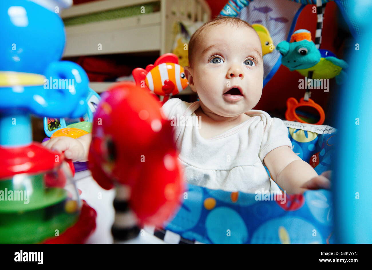Baby Girl Playing in Activity Station Stock Photo - Alamy