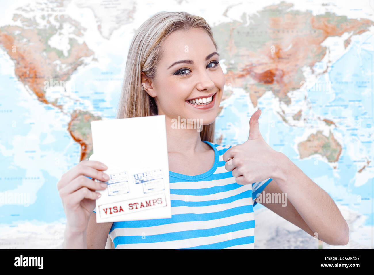 Beautiful young woman near map Stock Photo - Alamy