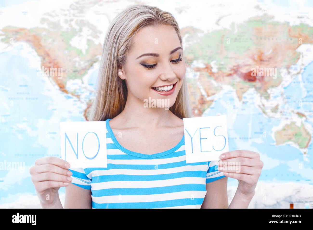 Beautiful young woman near map Stock Photo - Alamy