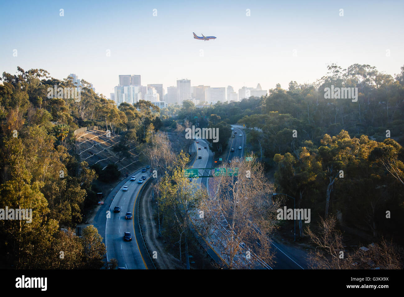 Landing airplane over California Route 163 and the San Diego Skyline ...