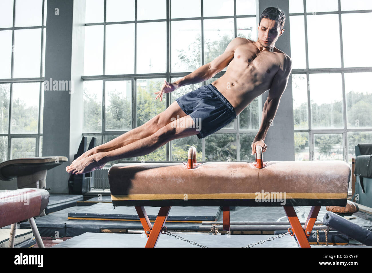 The sportsman during difficult exercise, sports gymnastics Stock Photo ...