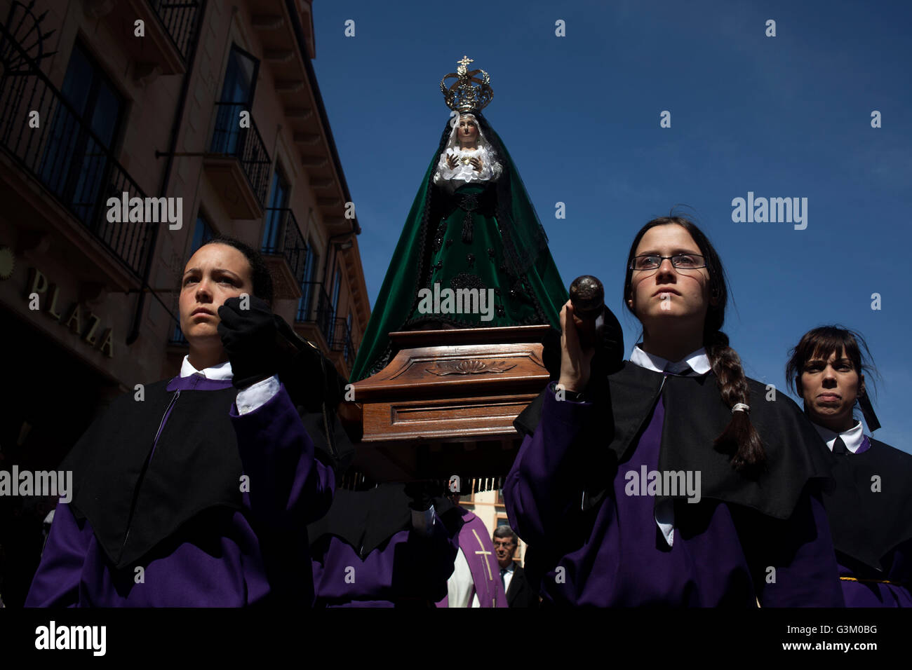 Female teenagers carry an image of the Virgin Mary during an Easter ...