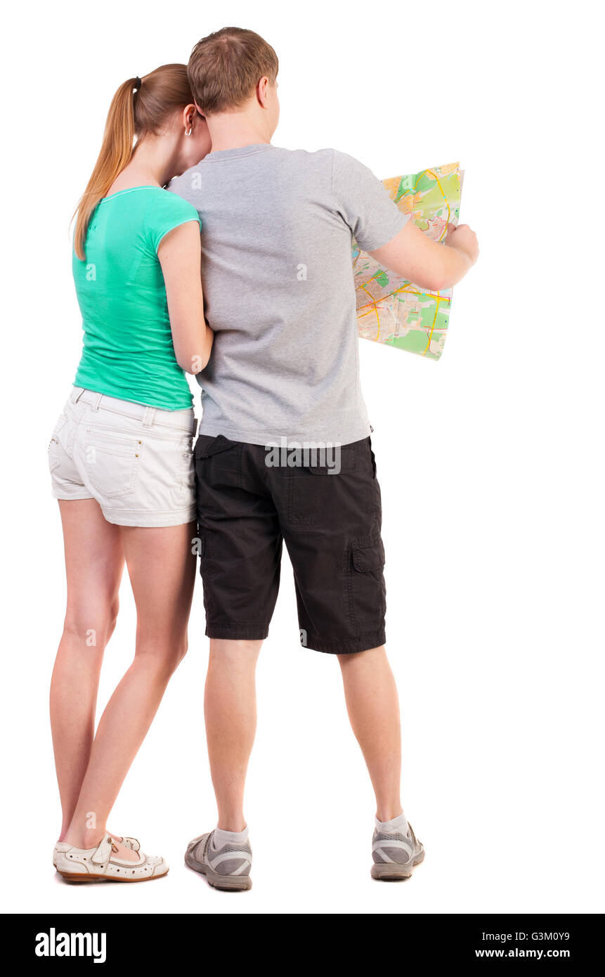 Back view journey of the young couple looking at the map. Rear view ...
