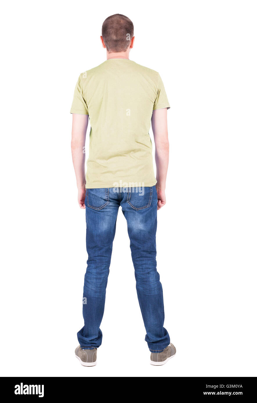 Back view of young man in t-shirt and jeans looking. Standing young guy ...