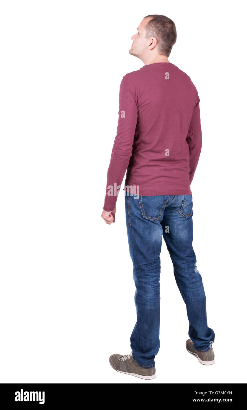 Back view of young man in t-shirt and jeans looking. Standing young guy ...