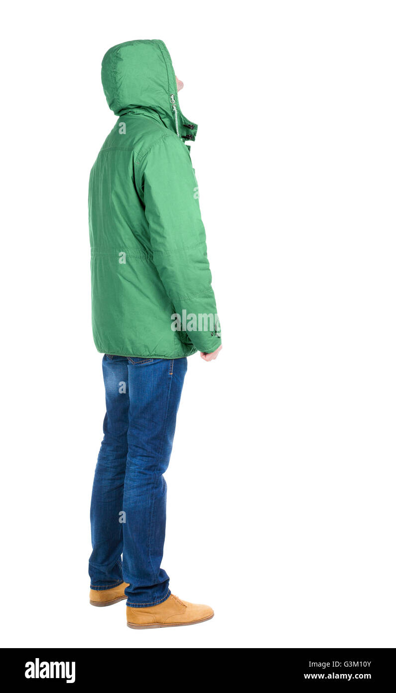 Back view of handsome man in winter jacket looking up. Standing young ...