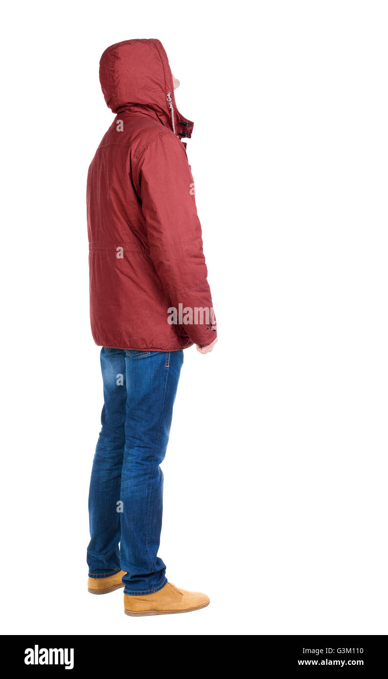 Back view of handsome man in winter jacket looking up. Standing young ...