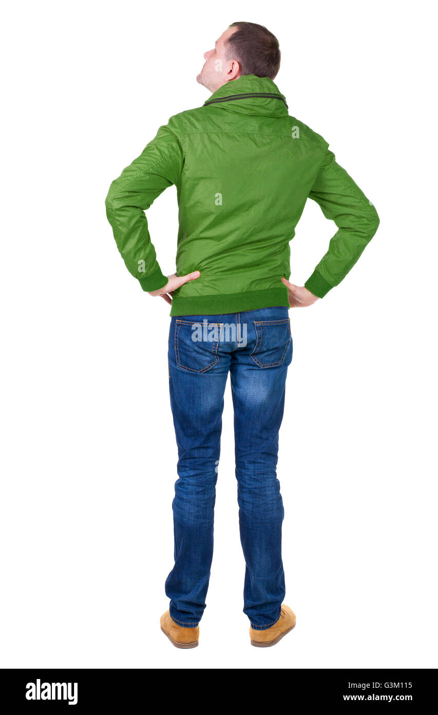 Back view of handsome man in brown windcheater looking up. Standing ...