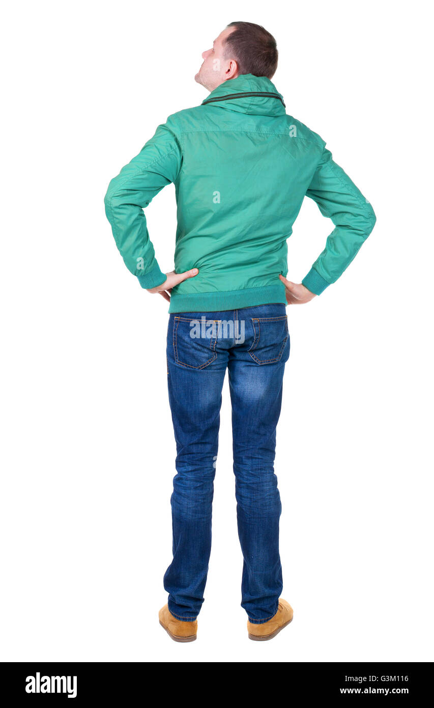 Back view of handsome man in brown windcheater looking up. Standing ...