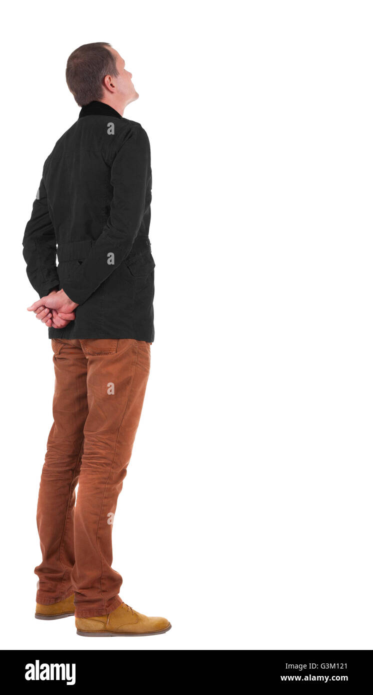 Back view of stylishly dressed man in a brown jackett looking up ...