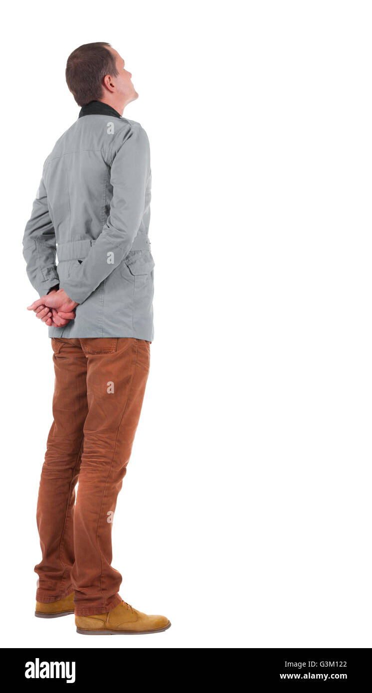 Back view of stylishly dressed man in a brown jackett looking up ...